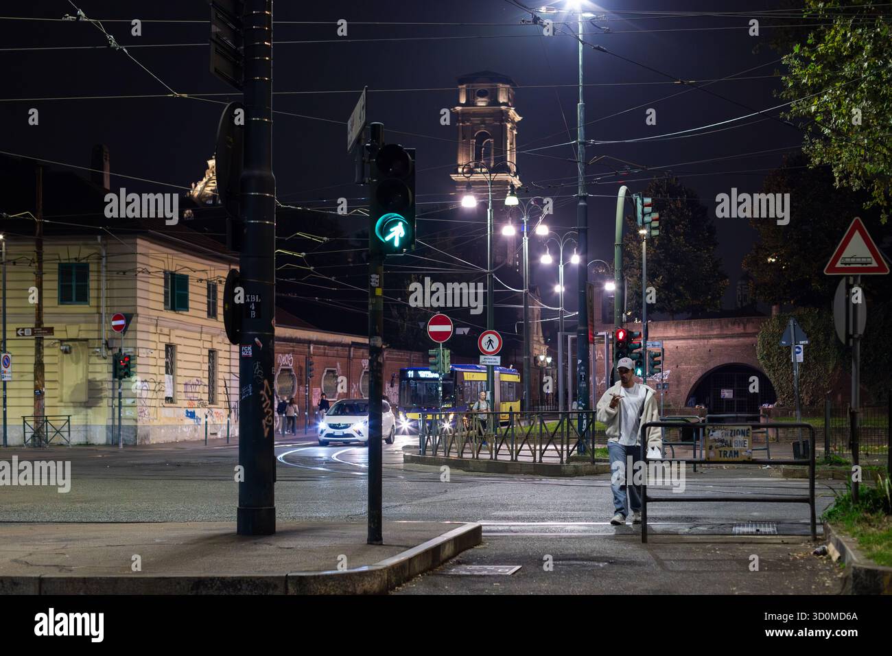 Night view of a street in Turin. The historic bell tower of Turin ...