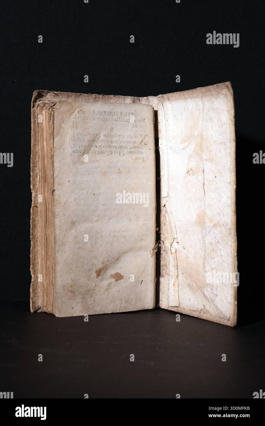 Open pages of a very old, deteriorated book (early print), showing aged ...
