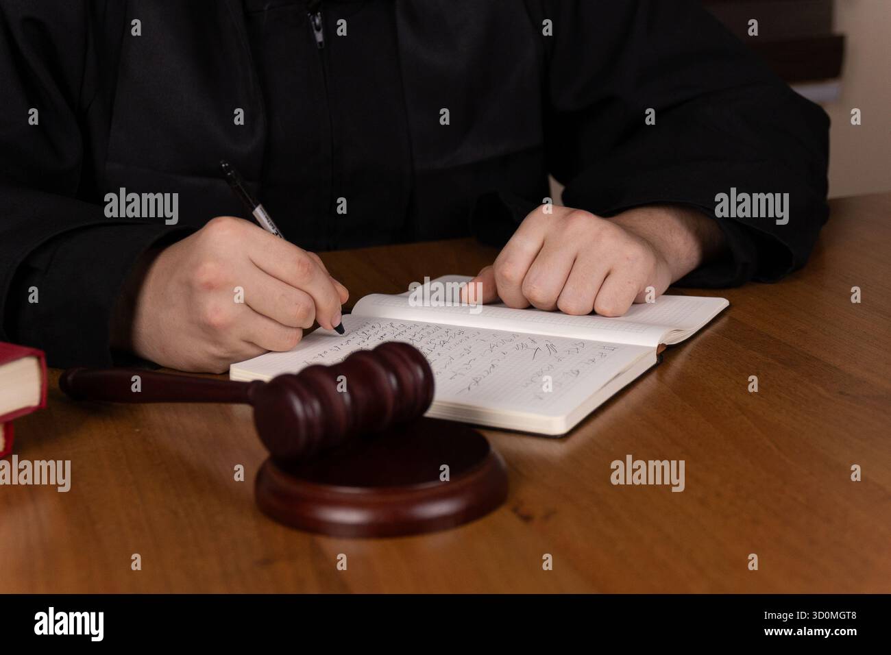 Judge writing document at desk in a courtroom Stock Photo - Alamy