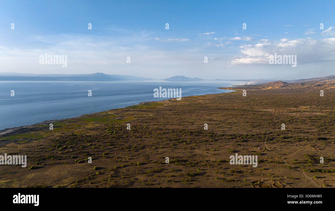 Aerial view of the tranquil, glassy waters meeting the arid, textured ...