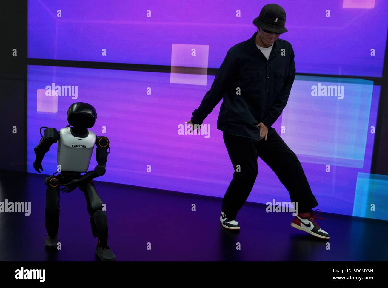 A dancer performs Michael Jackson dance moves with a Booster K1 robot ...