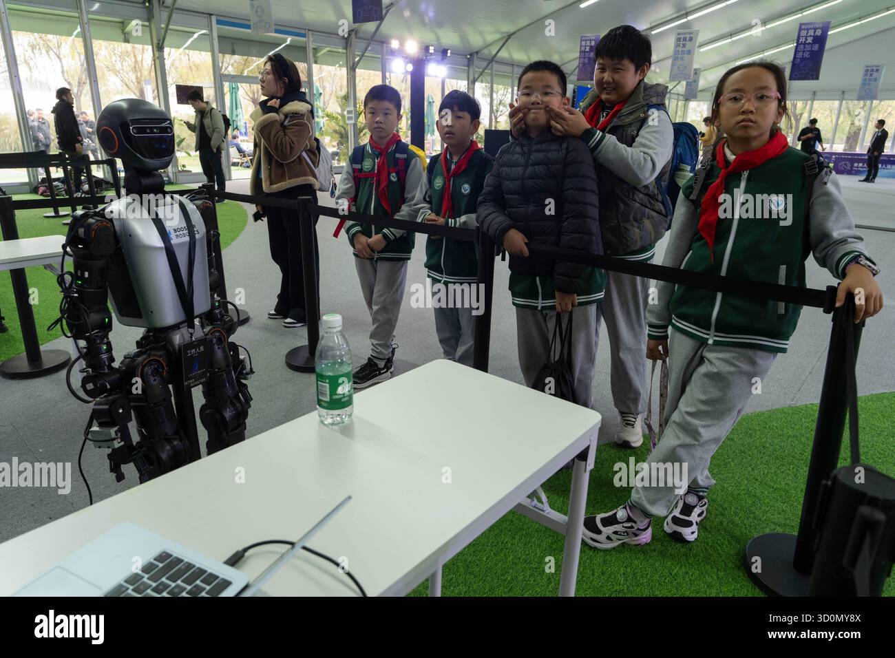 School children look at a demonstration for the Booster T1 robot at an ...