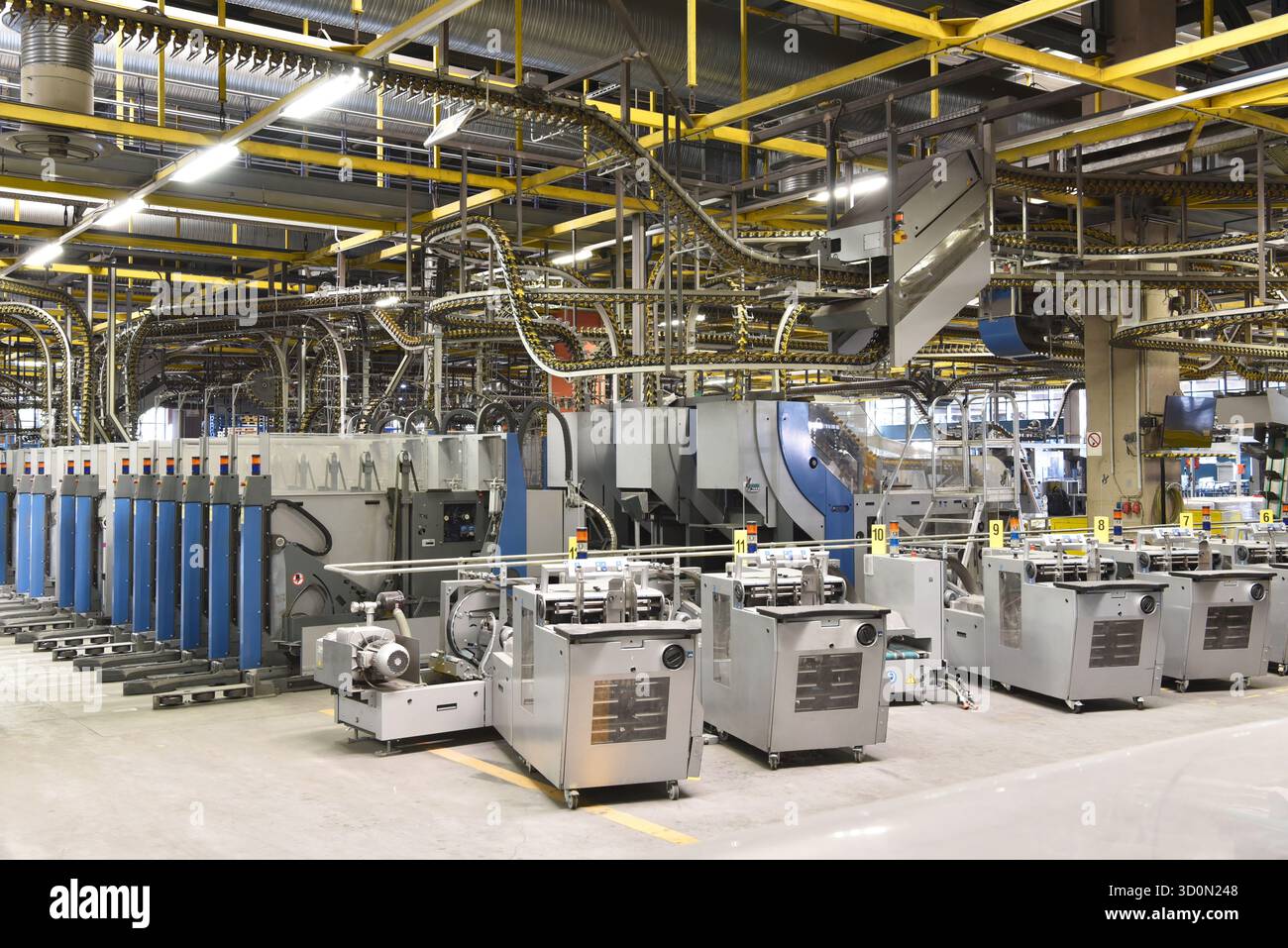 modern machines for transportation in a large print shop for production ...