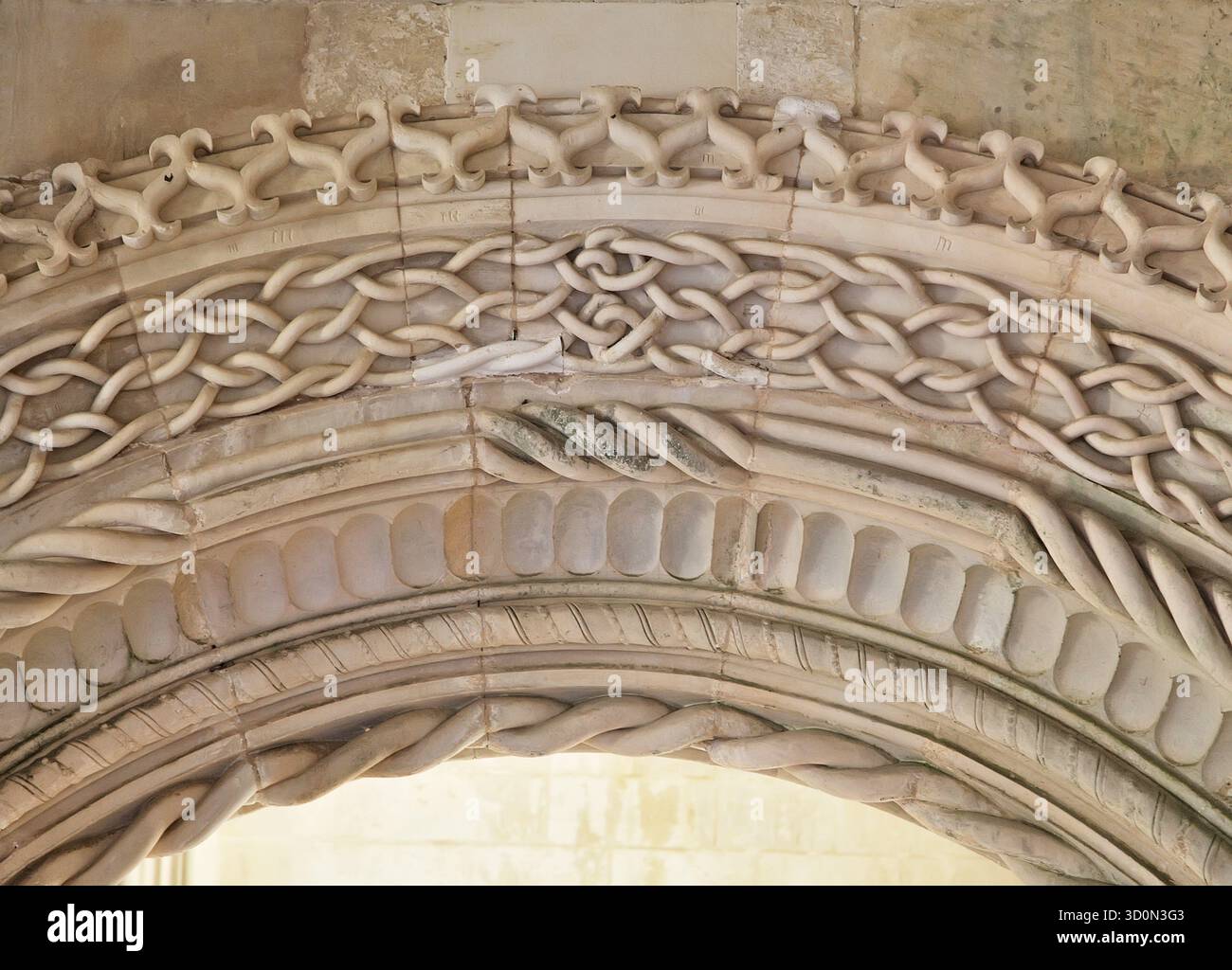 Detailed stone archway displays intricate patterns at Batalha monastery ...
