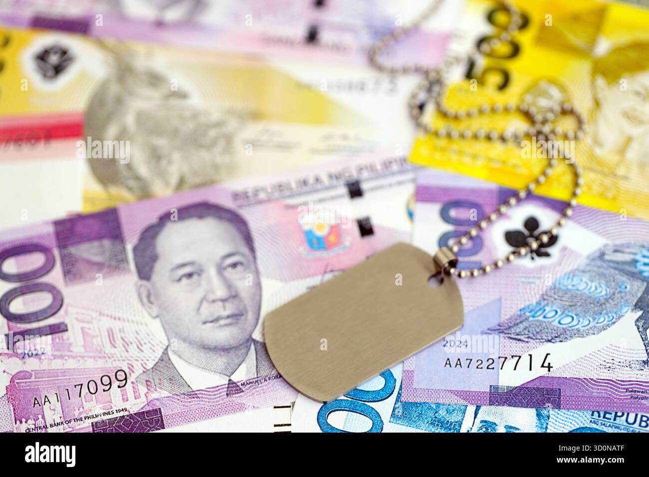 Philippines peso currency money bills and military token close up. The ...