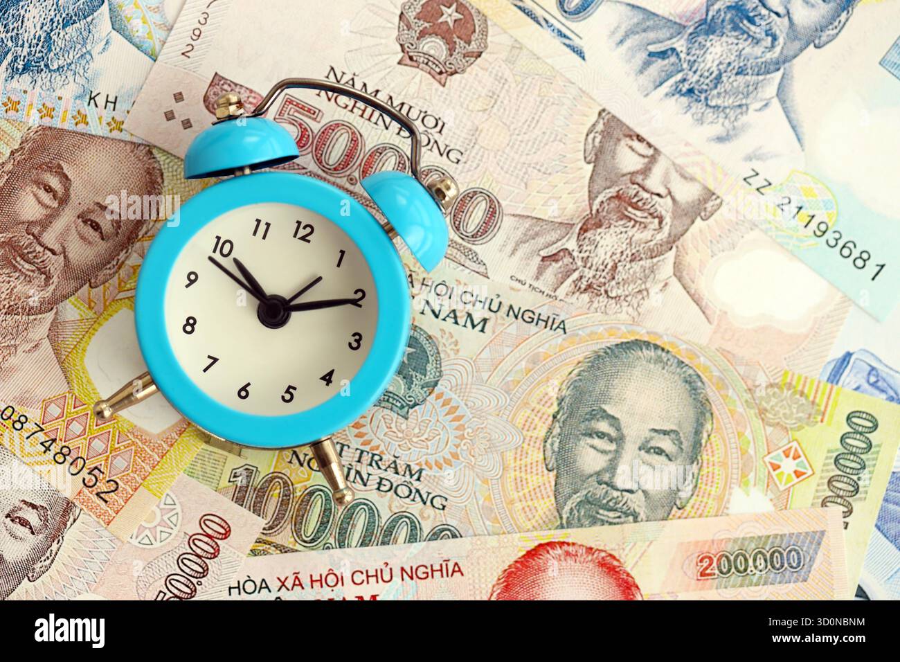 Vietnamese dong currency money bills and alarm clock close up. The ...
