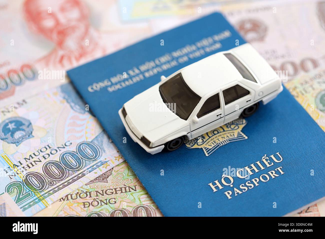 Vietnamese dong currency money bills and car with passport close up ...