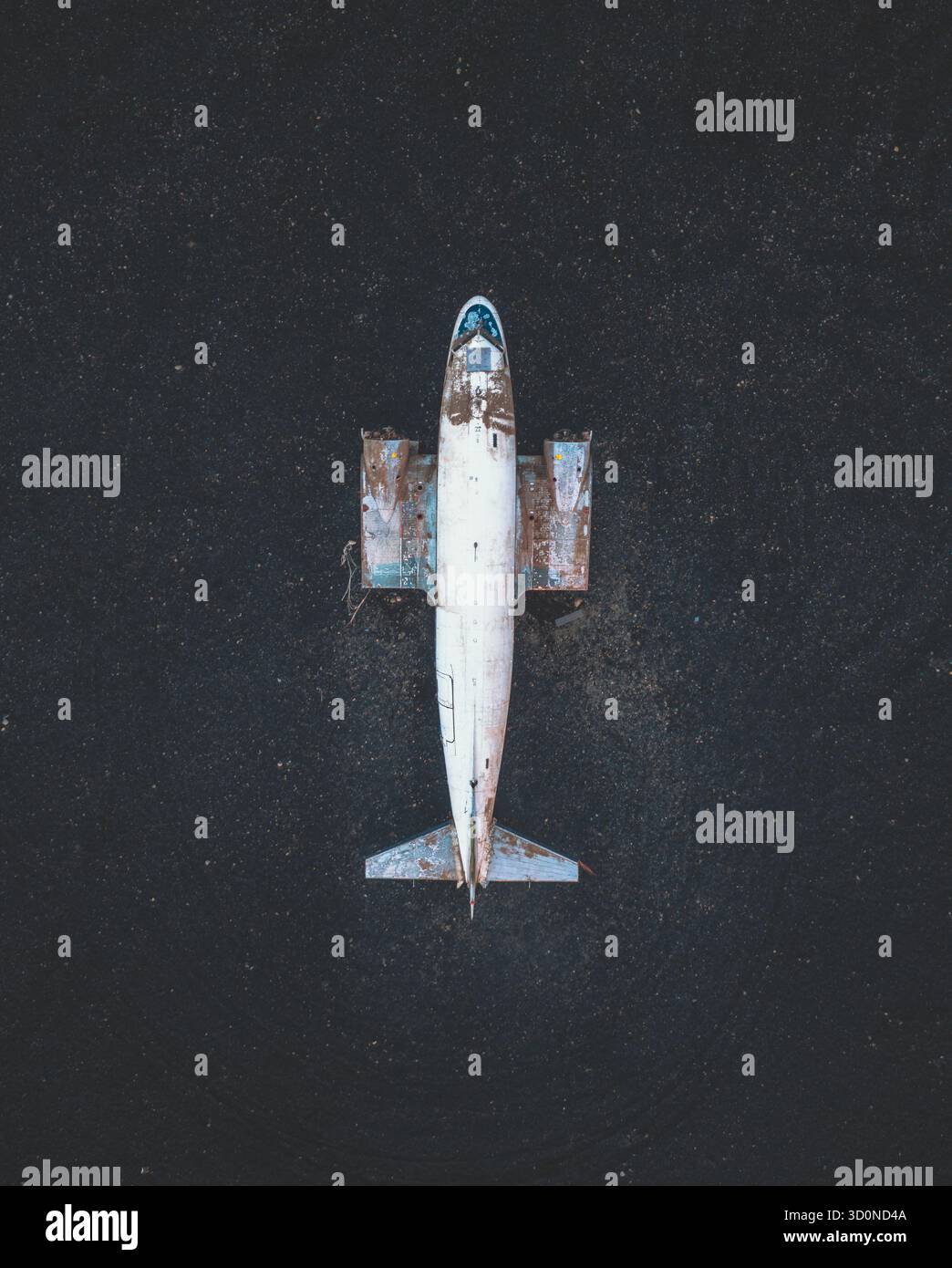Aerial view of a weathered DC-3 plane carcass resting starkly on the ...