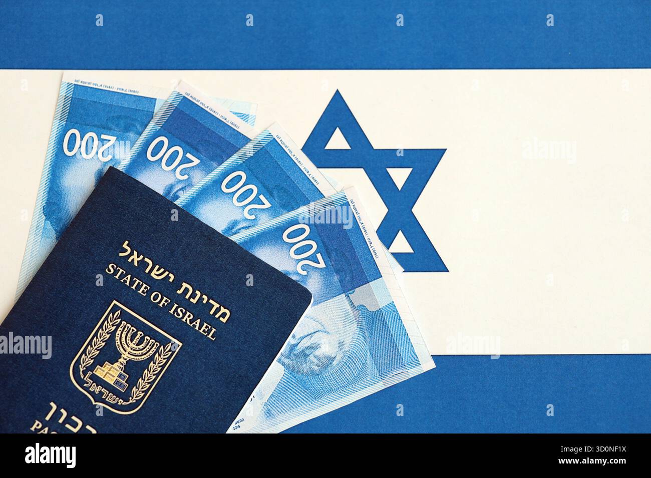 Israel New Shekels banknotes and passport on flag. The current Israel ...