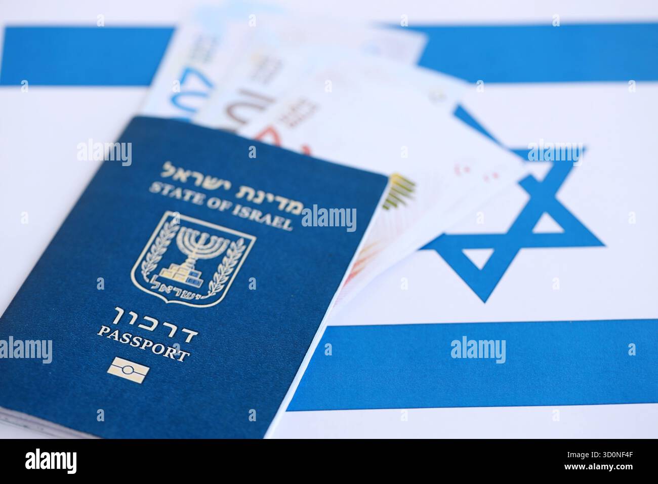 Israel New Shekels banknotes and passport on flag. The current Israel ...