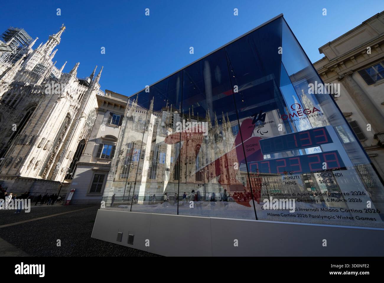 The Duomo gothic cathedral is reflected into the glass of the Milan ...