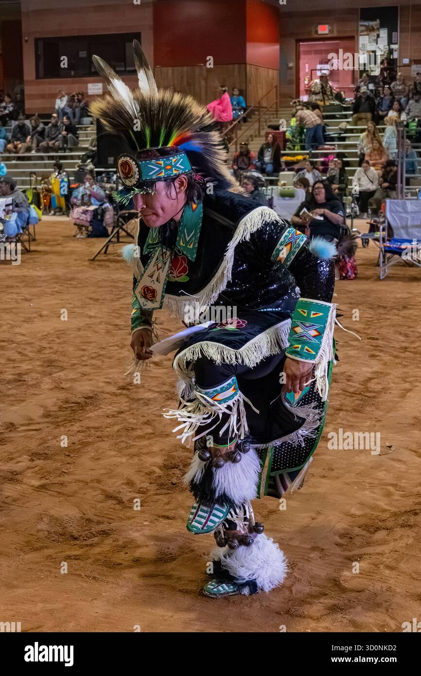 An Amerindian dancer in regalia with a bead mask dancing at a Native ...