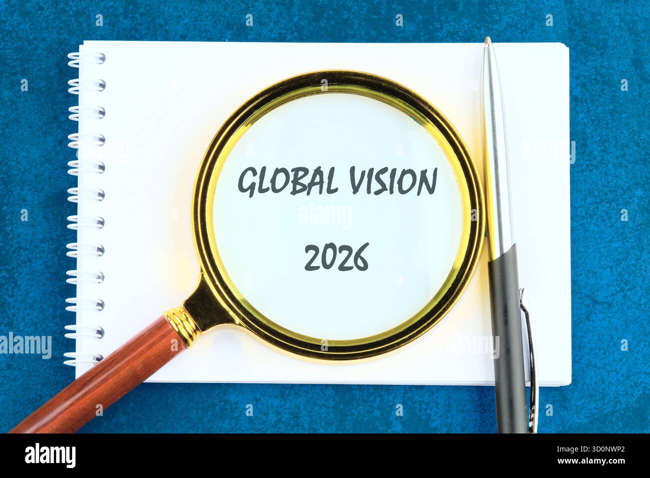 A magnifying glass rests on a notepad featuring the words Global Vision ...