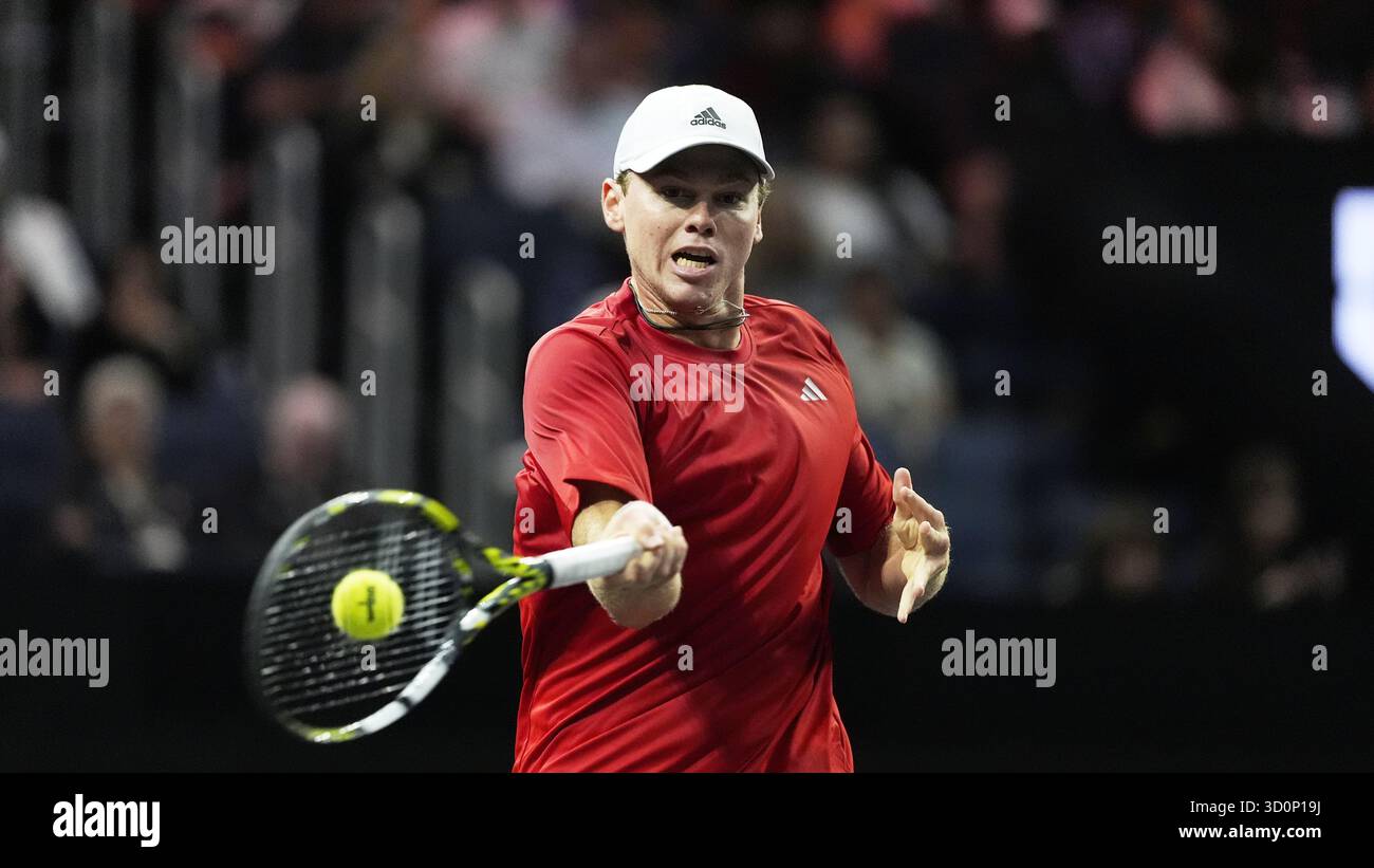 Team World's Alex Michelsen, of the United States, returns a shot ...