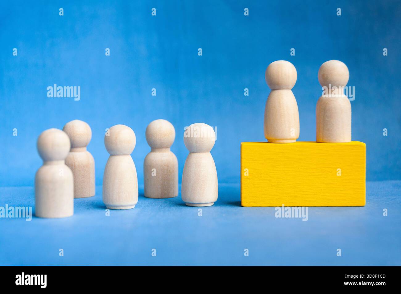 Two wooden peg figures on yellow block with blue backdrop showing unity ...