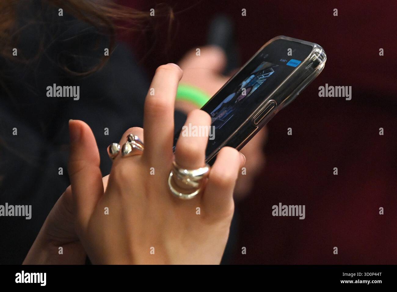 Marginal image: young woman typing on her smartphone. Chatting, sending ...