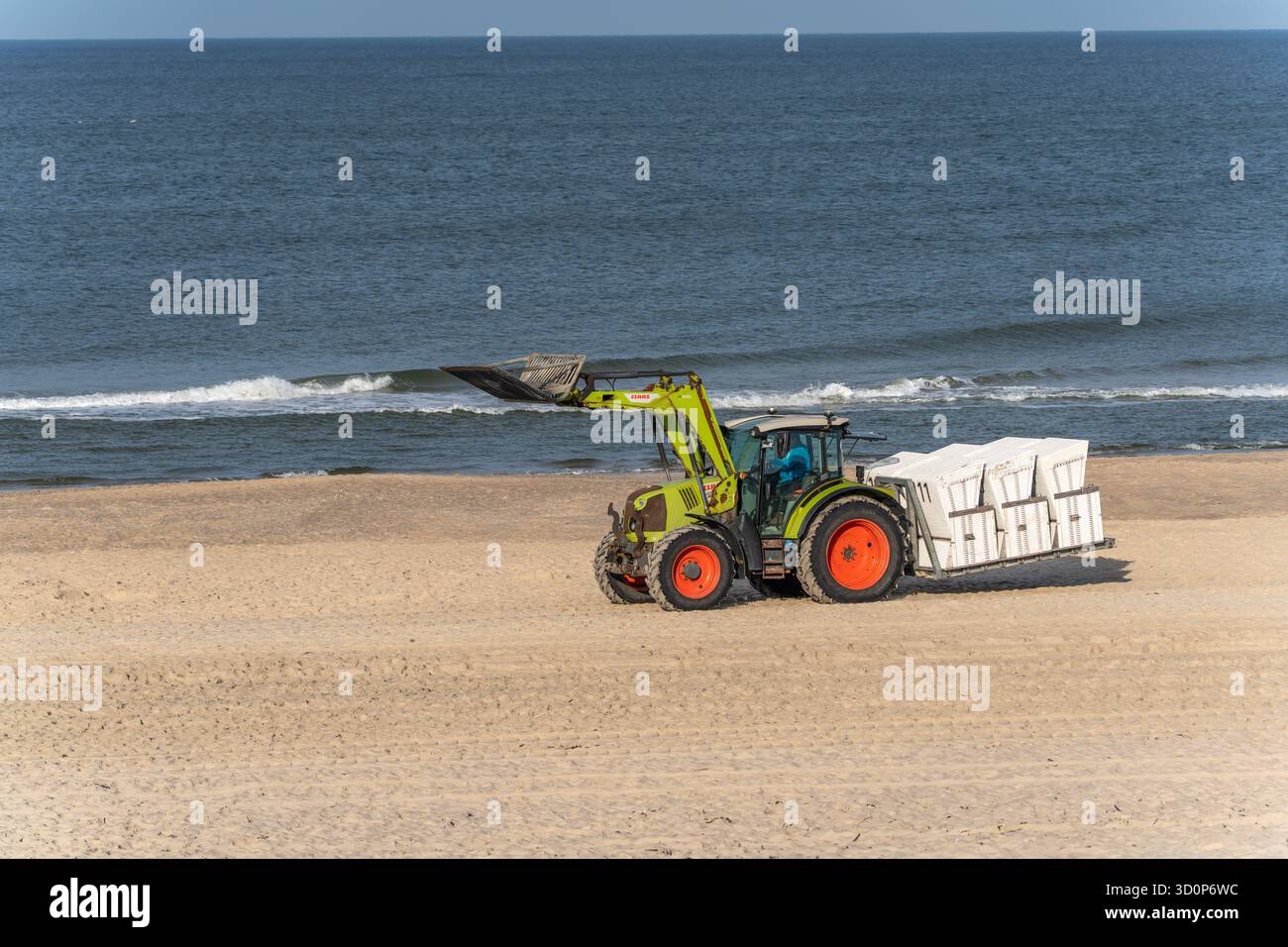 Germany Sylt October 2, 2025. Tractor on beach. A green Claas tractor ...