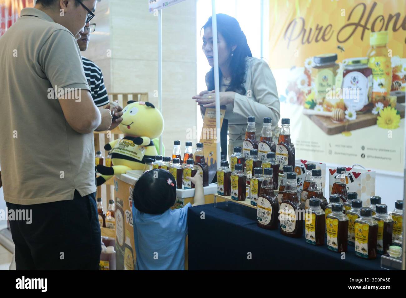 Yangon, Myanmar. 24th Oct, 2025. Visitors look at honey products of ...