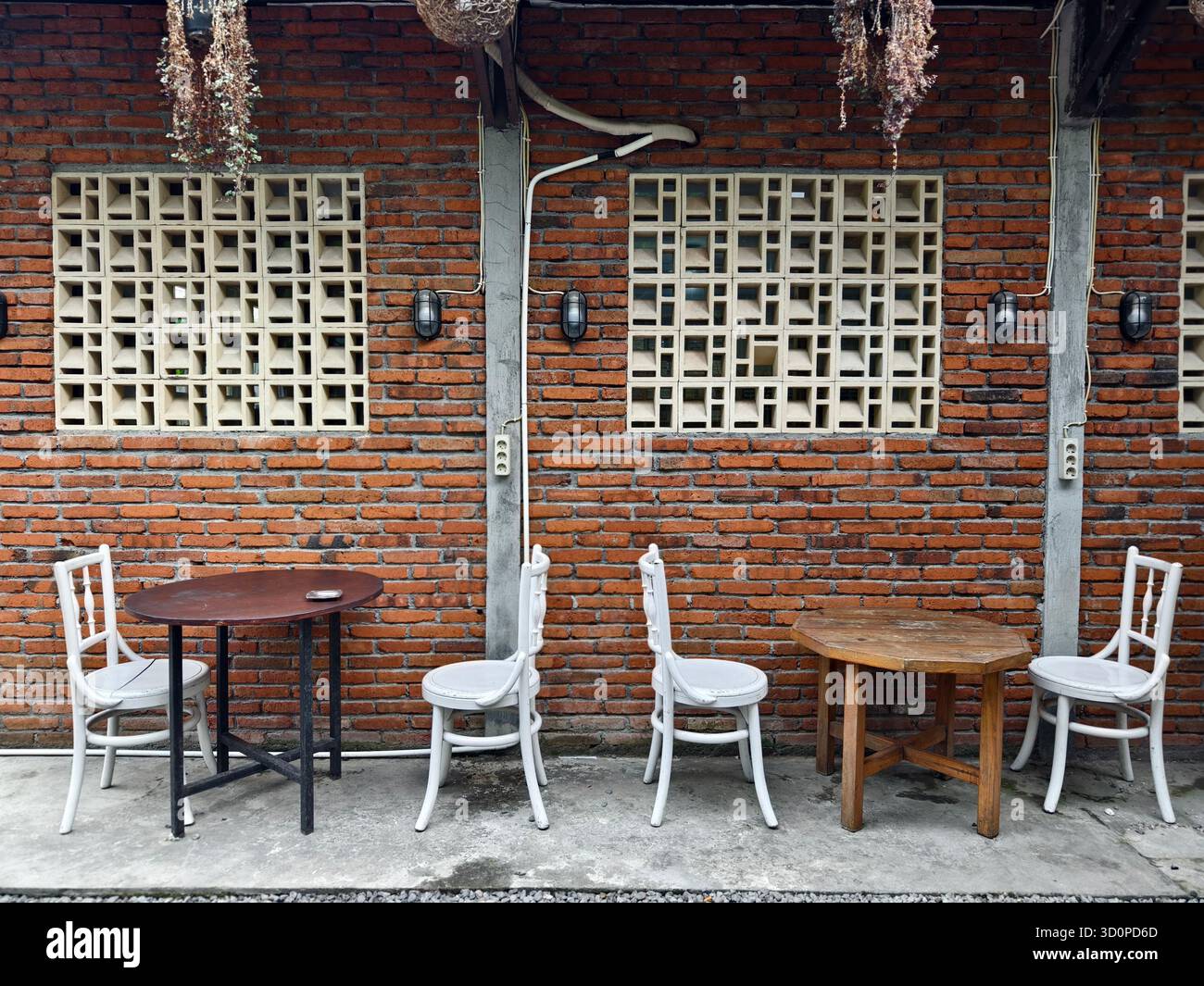 Rustic Outdoor Café Seating Against a red Brick Wall with decorative ...