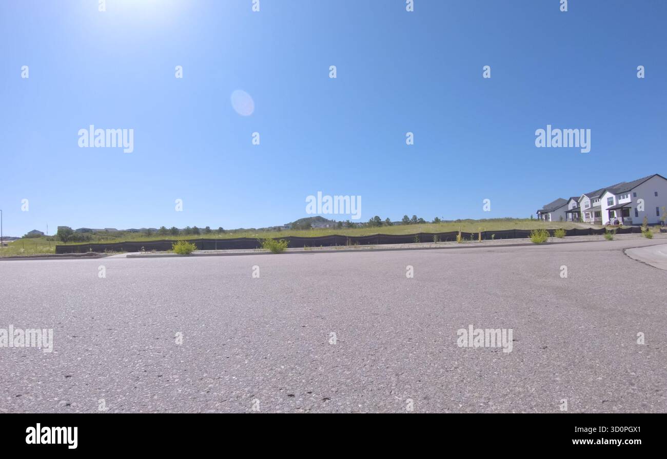 Suburban street with open field views Stock Photo - Alamy