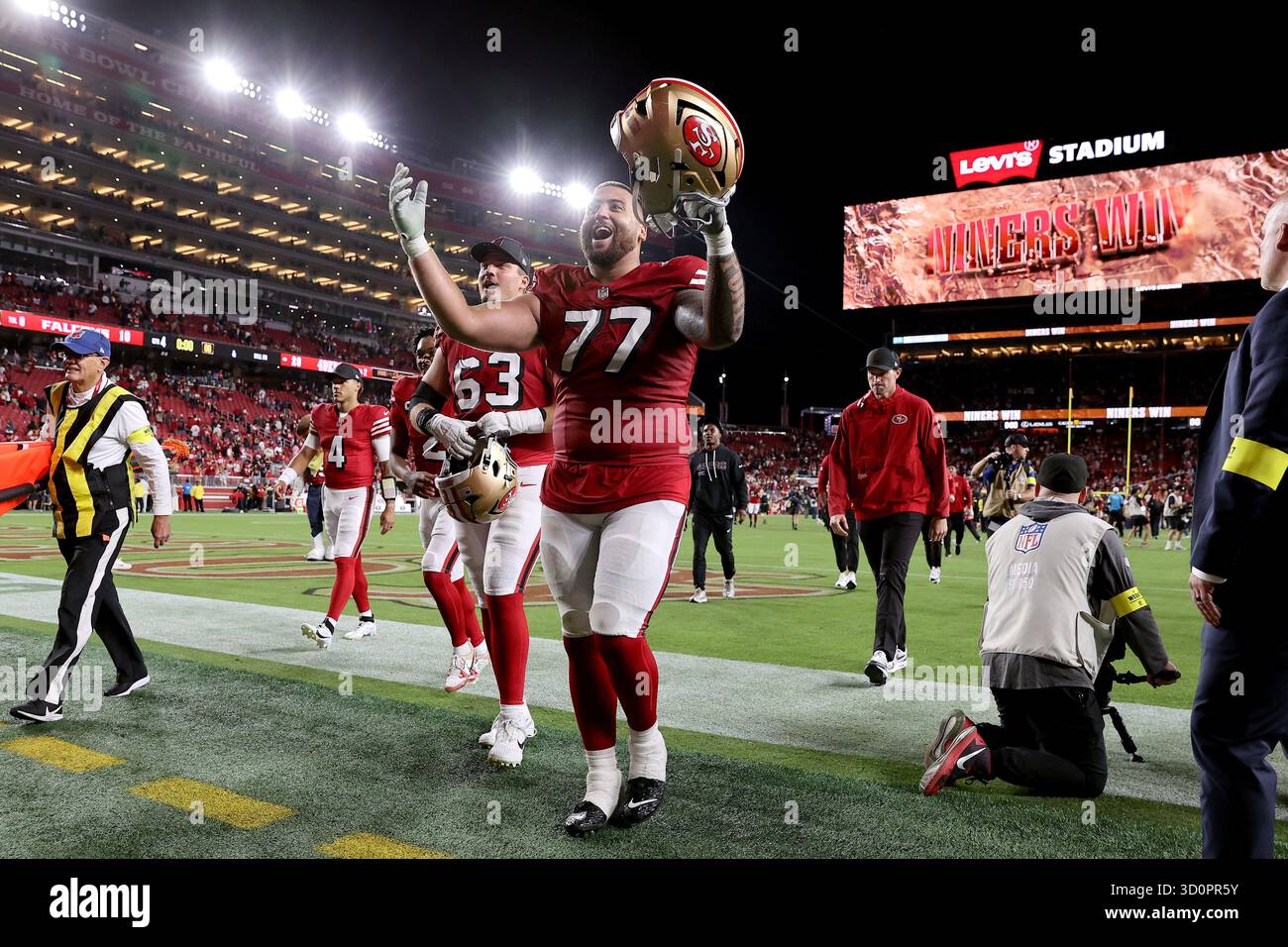 San Francisco 49ers offensive tackle Dominick Puni (77) walks off the ...