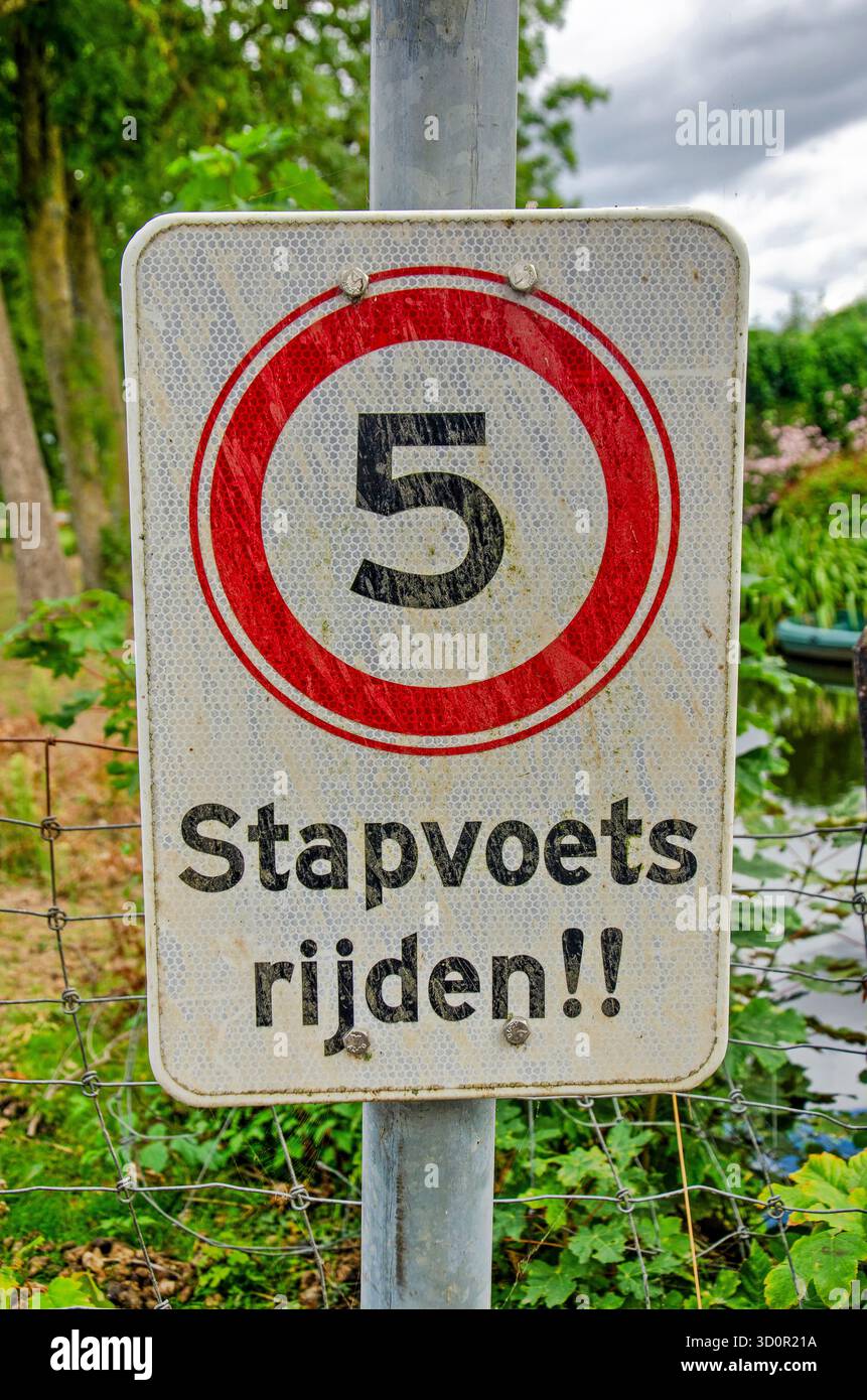 Sign shwoing a maximum speed of 5 kilomtre per hour and in Dutch the ...