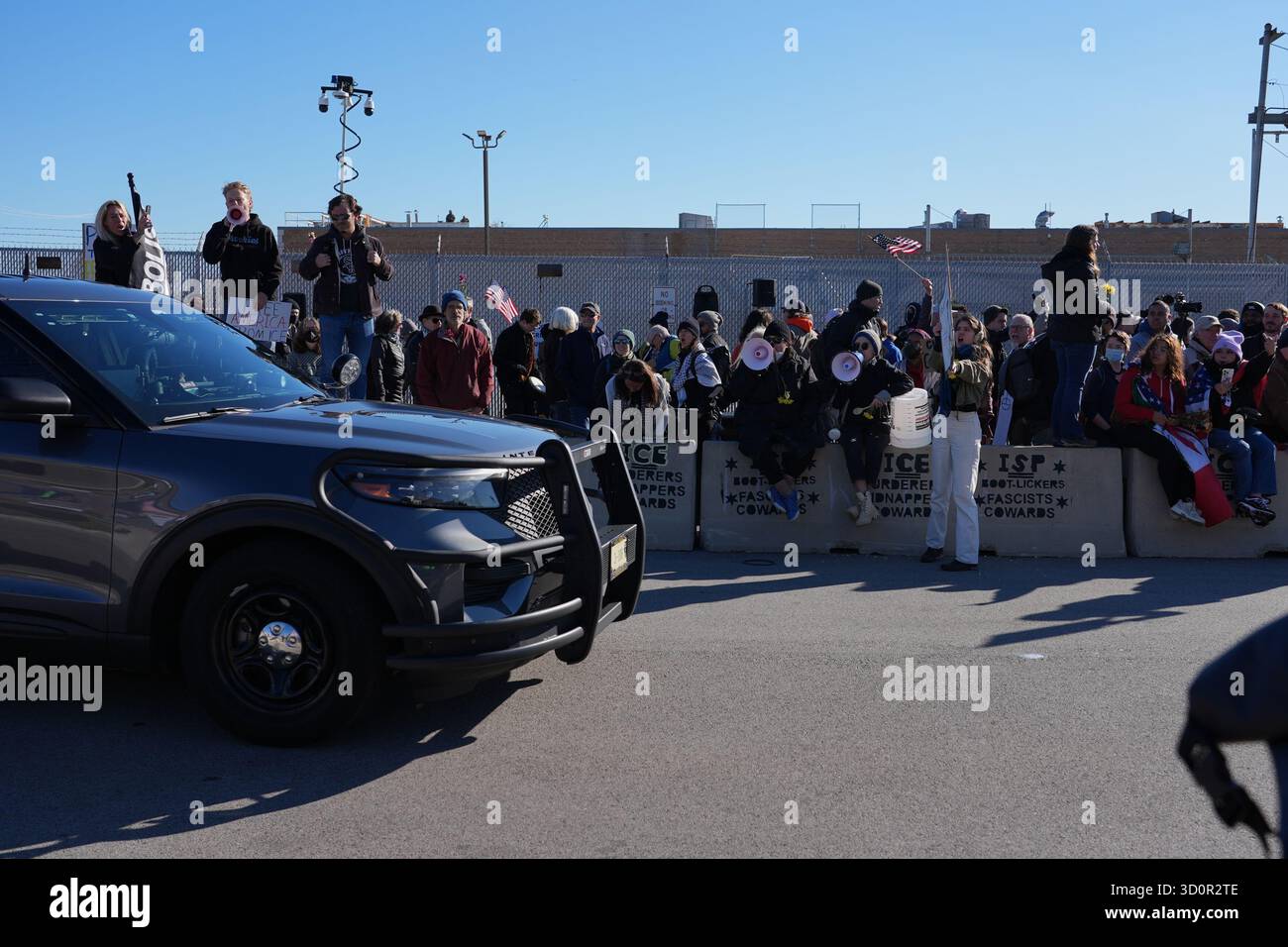Protesters yell as a vehicle leaves an ICE processing facility in ...