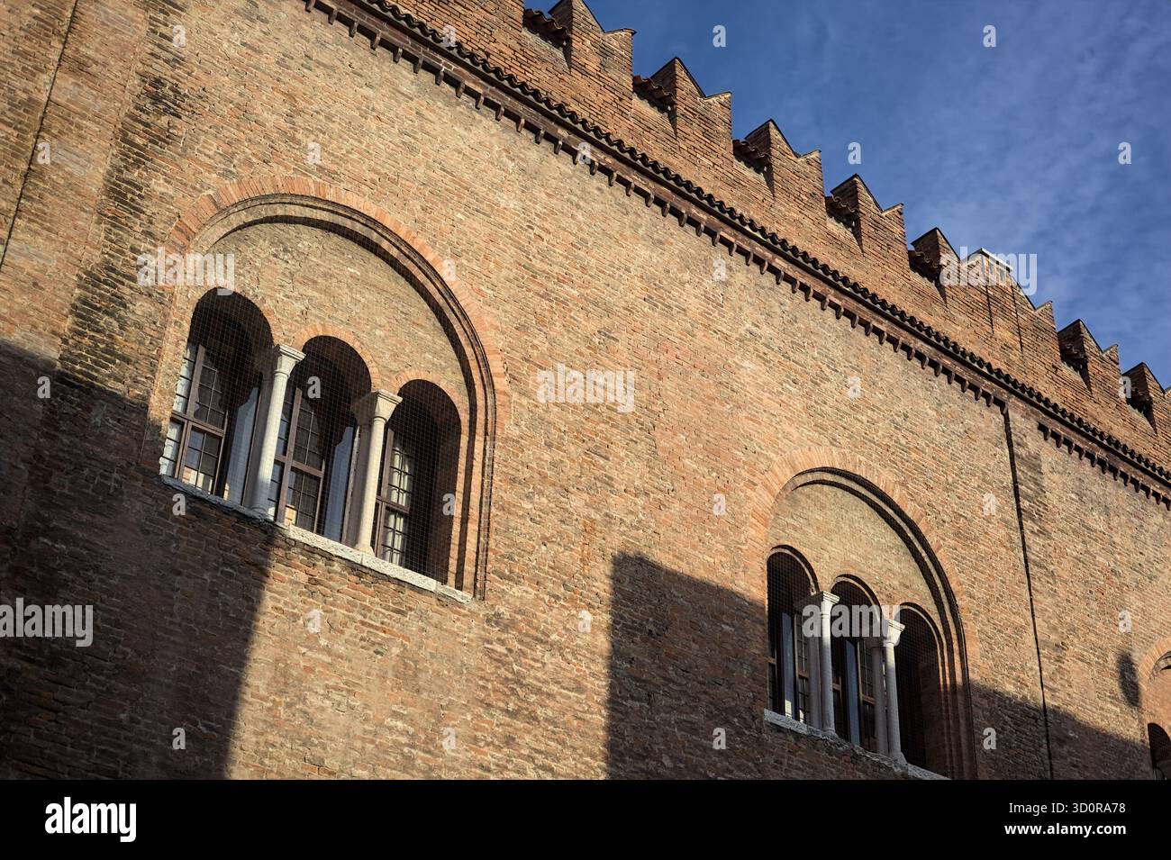 Section of the facade of a palace with arched windows and the sky in ...