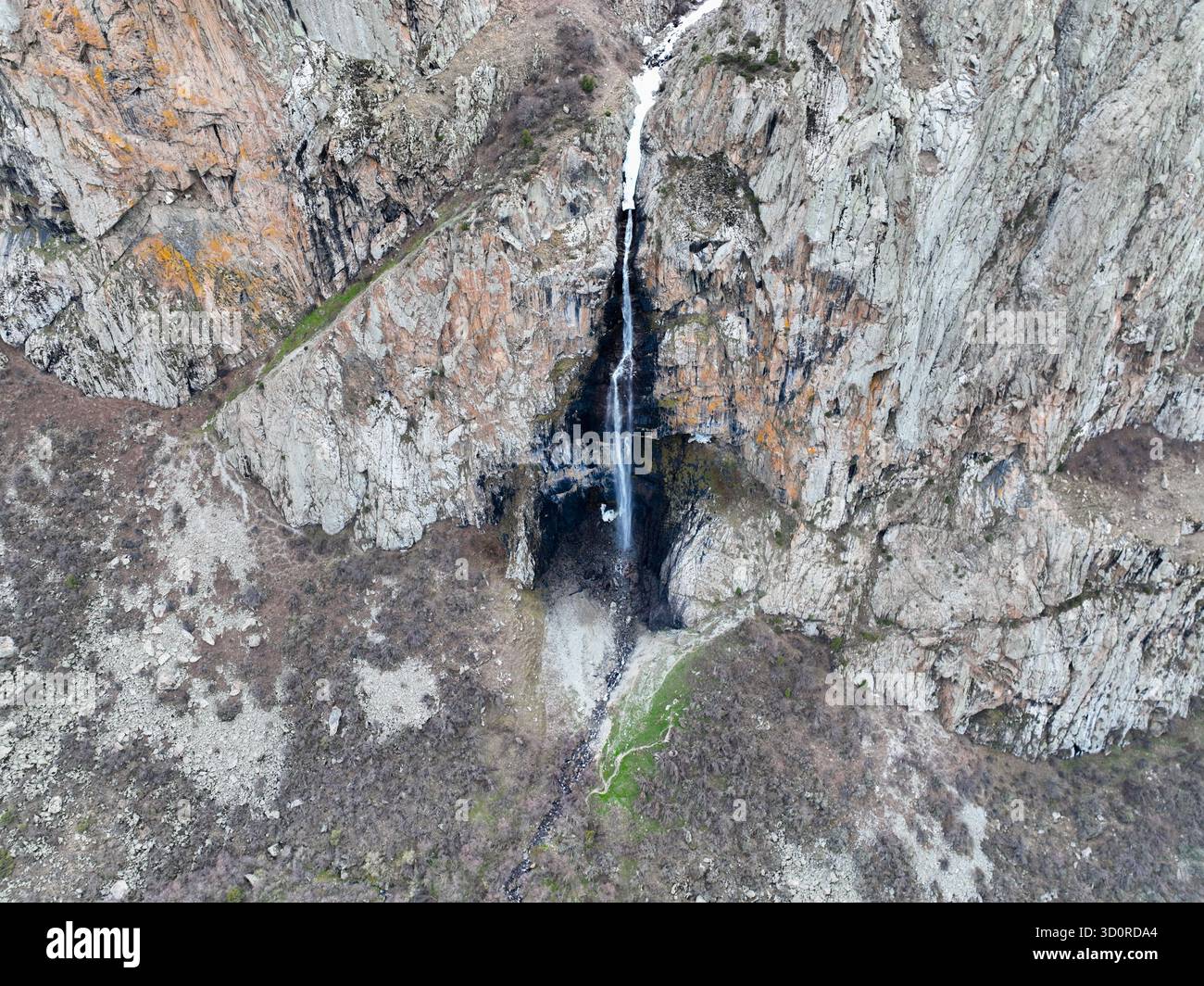 Direct overhead vertical aerial view looking down at a tall waterfall ...