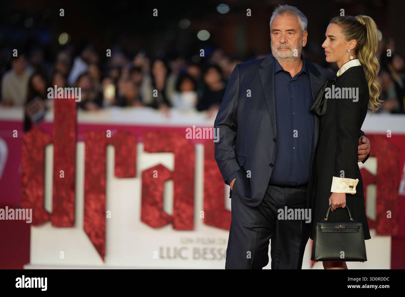 Luc Besson and Sarah Saldmann pose for photos on the red carpet for the ...