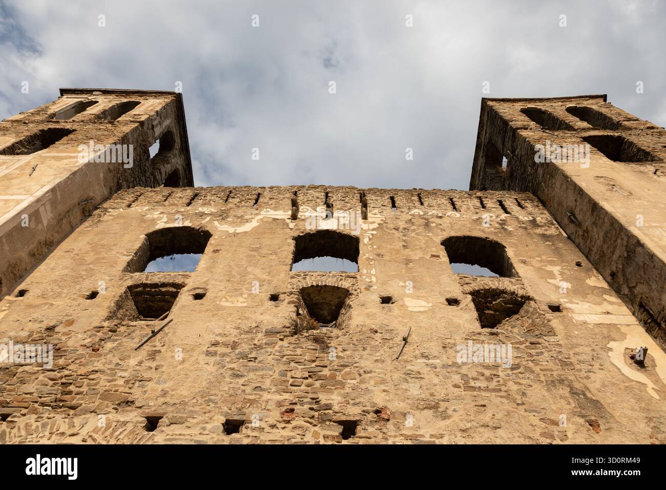Low angle view of an ancient castle wall with medieval stone arches and ...