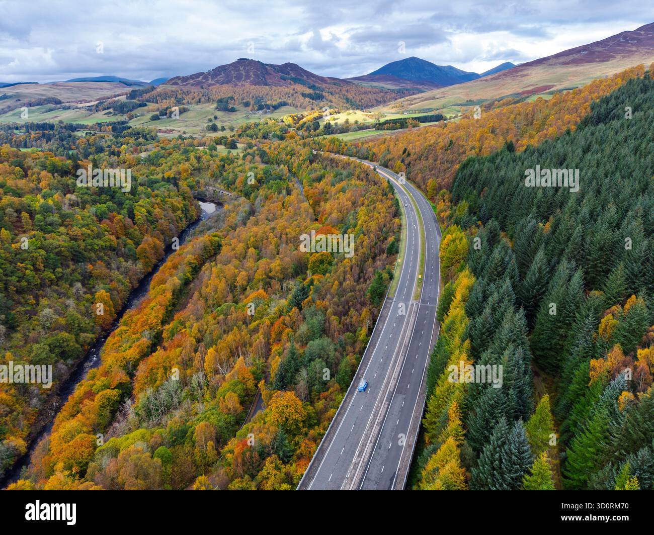 Aerial views of autumn colours in trees beside the A9 highway viaduct ...