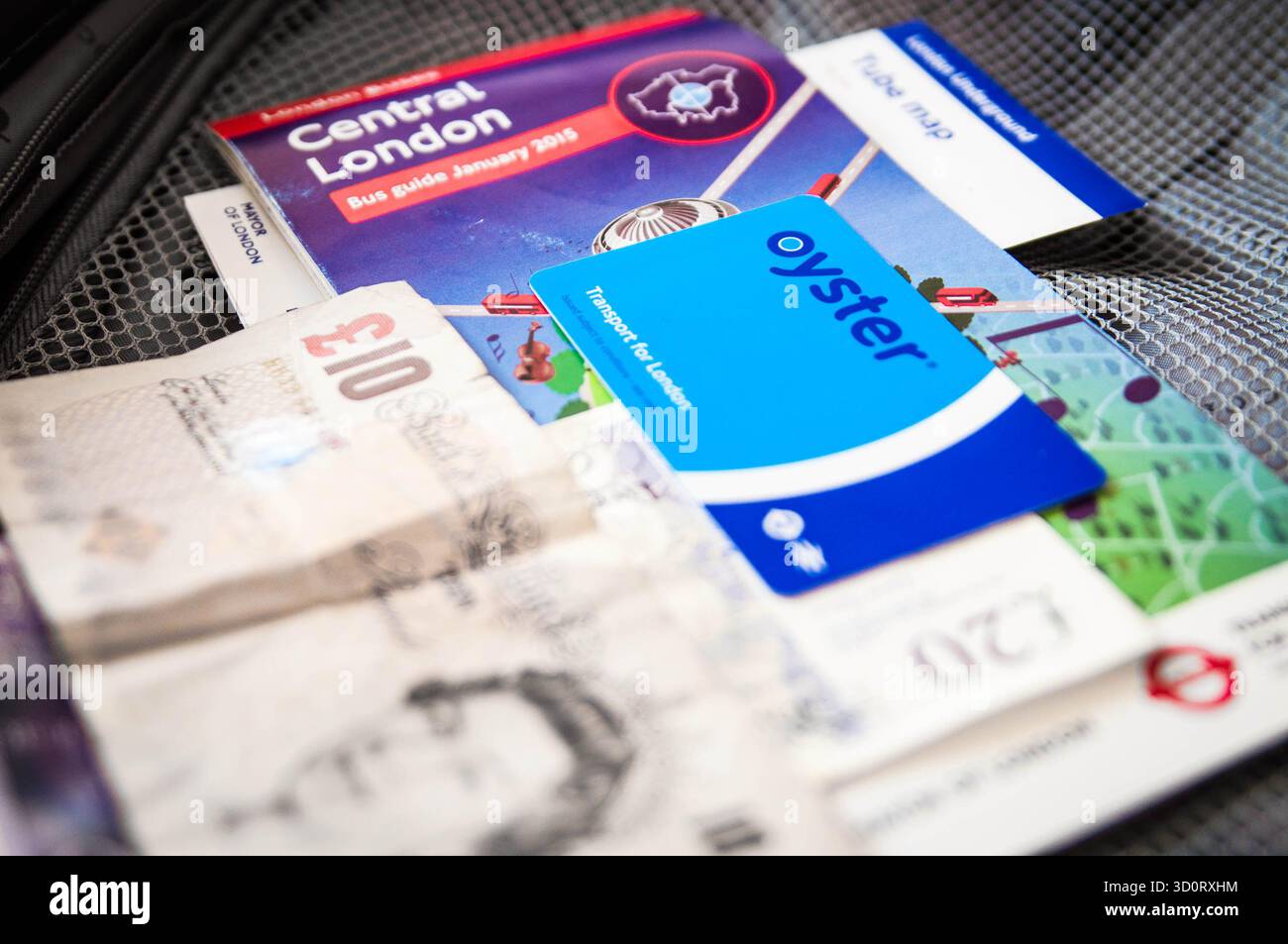 Oyster card, 10-pound banknote and a map of central London lying flat ...