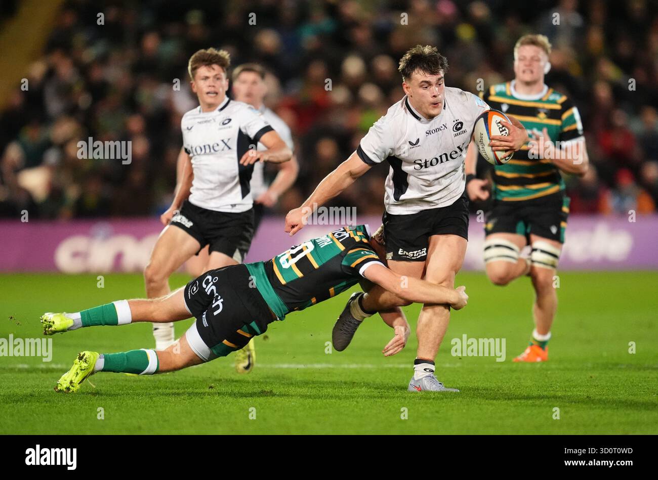 Saracens' Theo Dan is tackled by Northampton Saints' Fin Smith during ...
