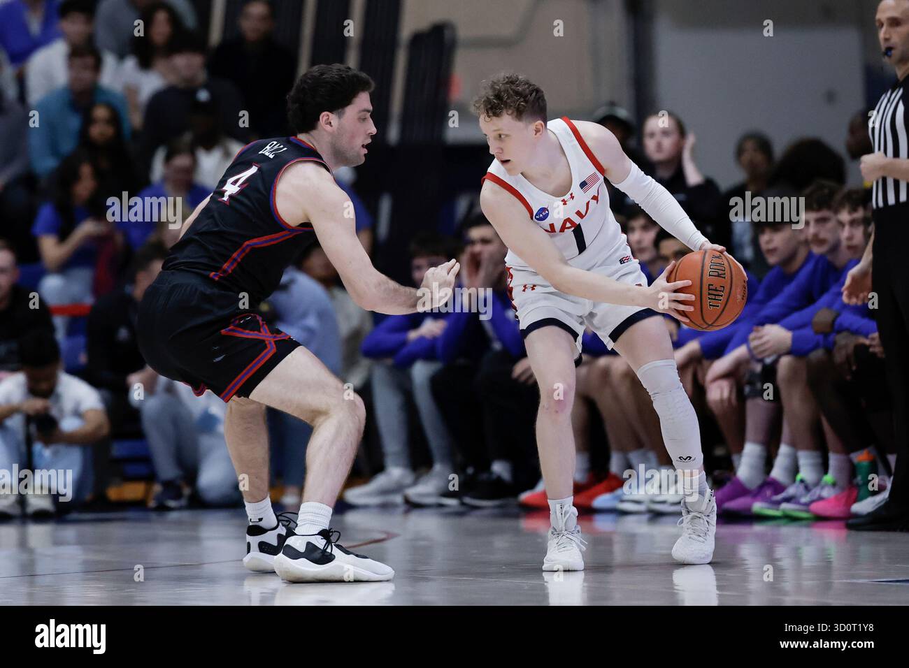 FILE - Navy guard Austin Benigni (1) controls the ball against American ...