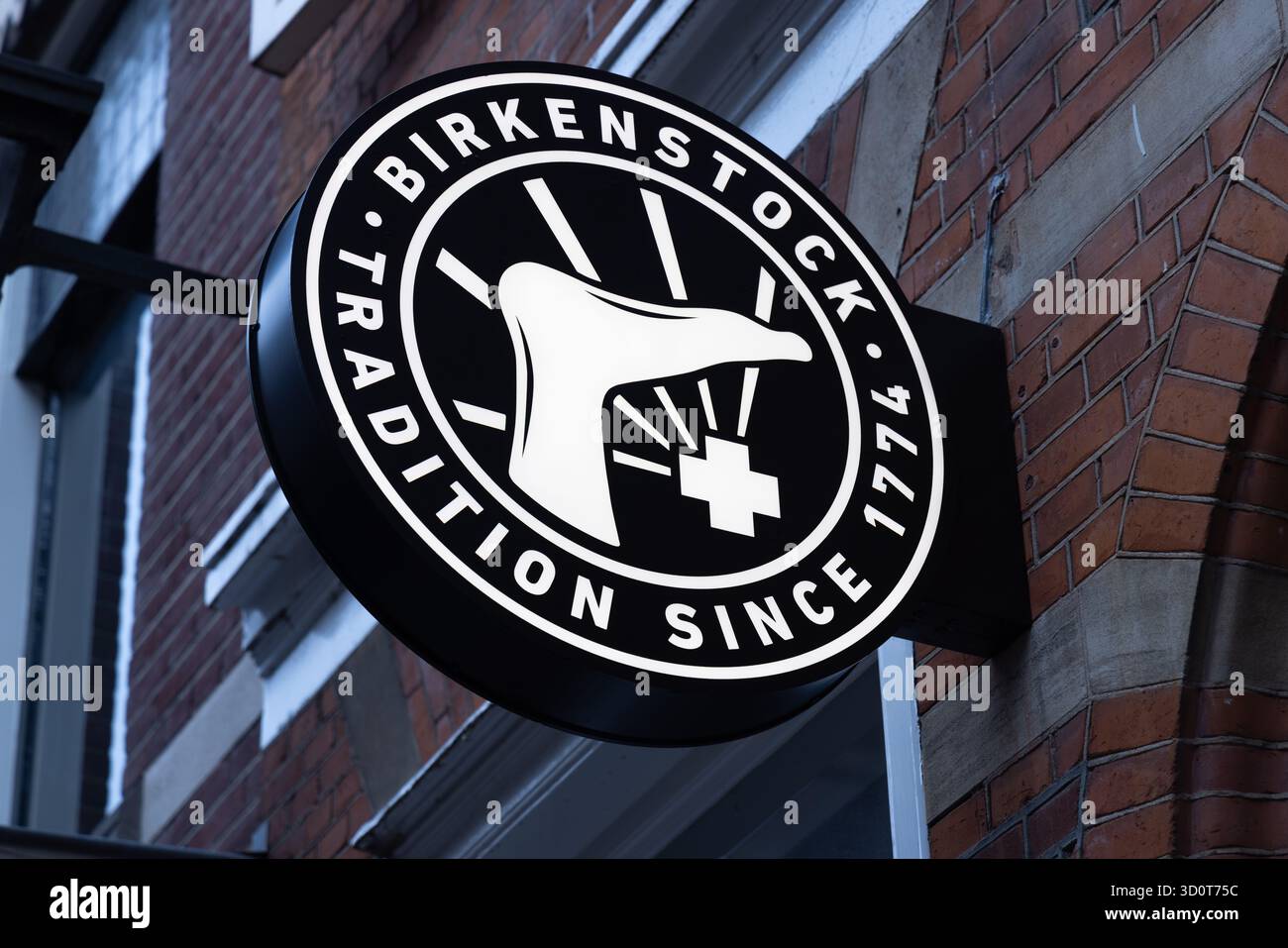 Description: Close-up of an illuminated black and white Birkenstock ...