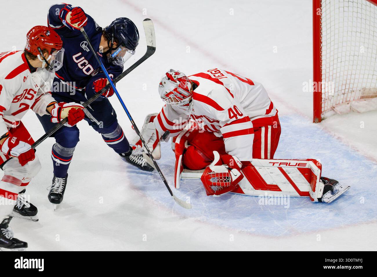 Boston University defenseman Sascha Boumedienne (78) helps goalie ...