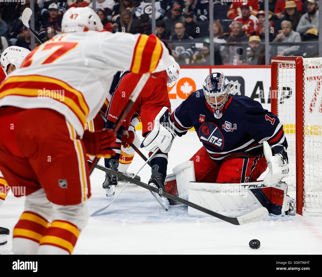 Winnipeg Jets goaltender Eric Comrie (1) keeps his eye on the puck ...