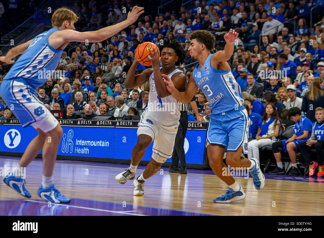 BYU guard Robert Wright III (1) goes to the basket through the defense ...