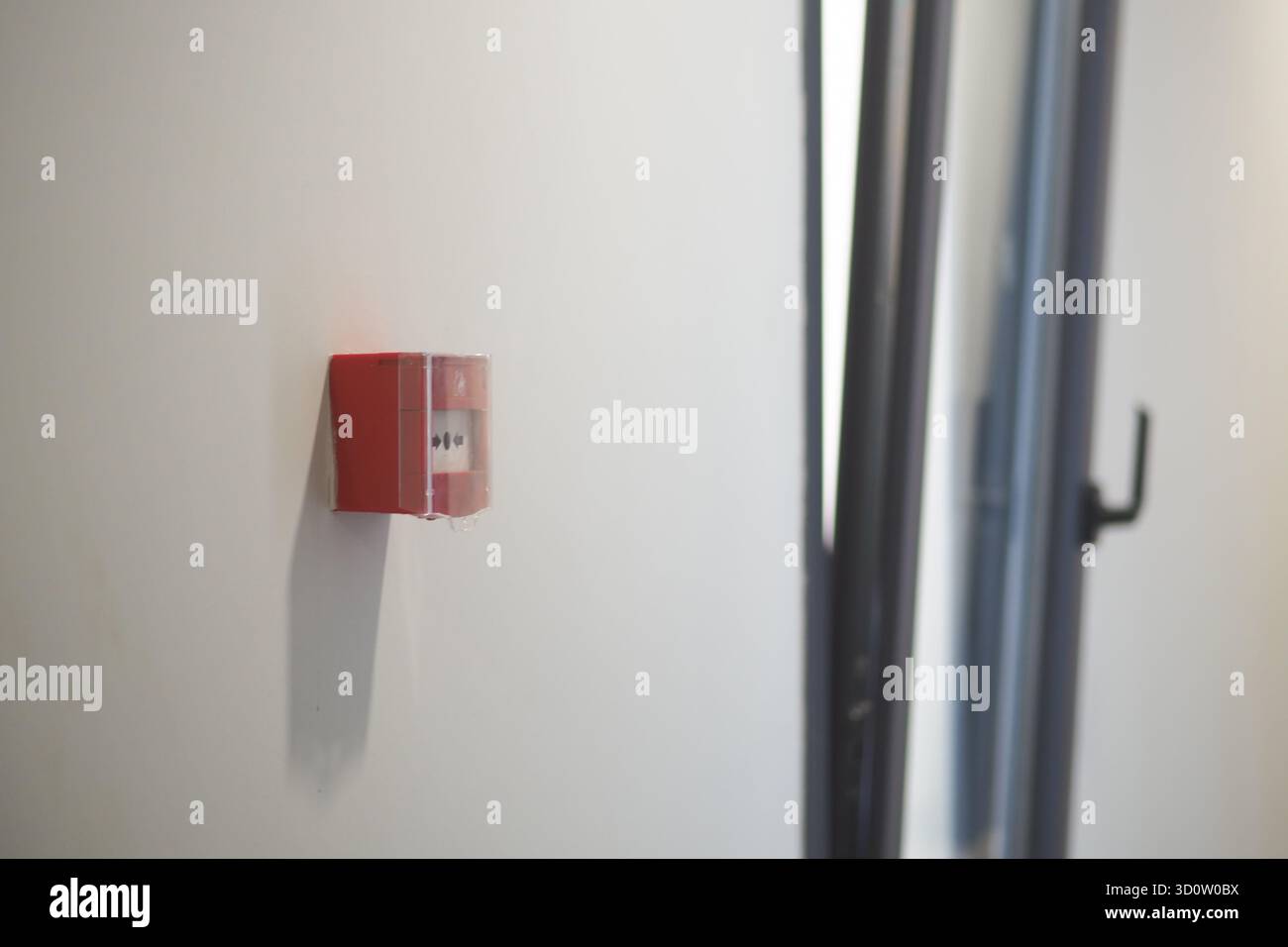Fire alarm installed on indoor wall in building hallway Stock Photo - Alamy