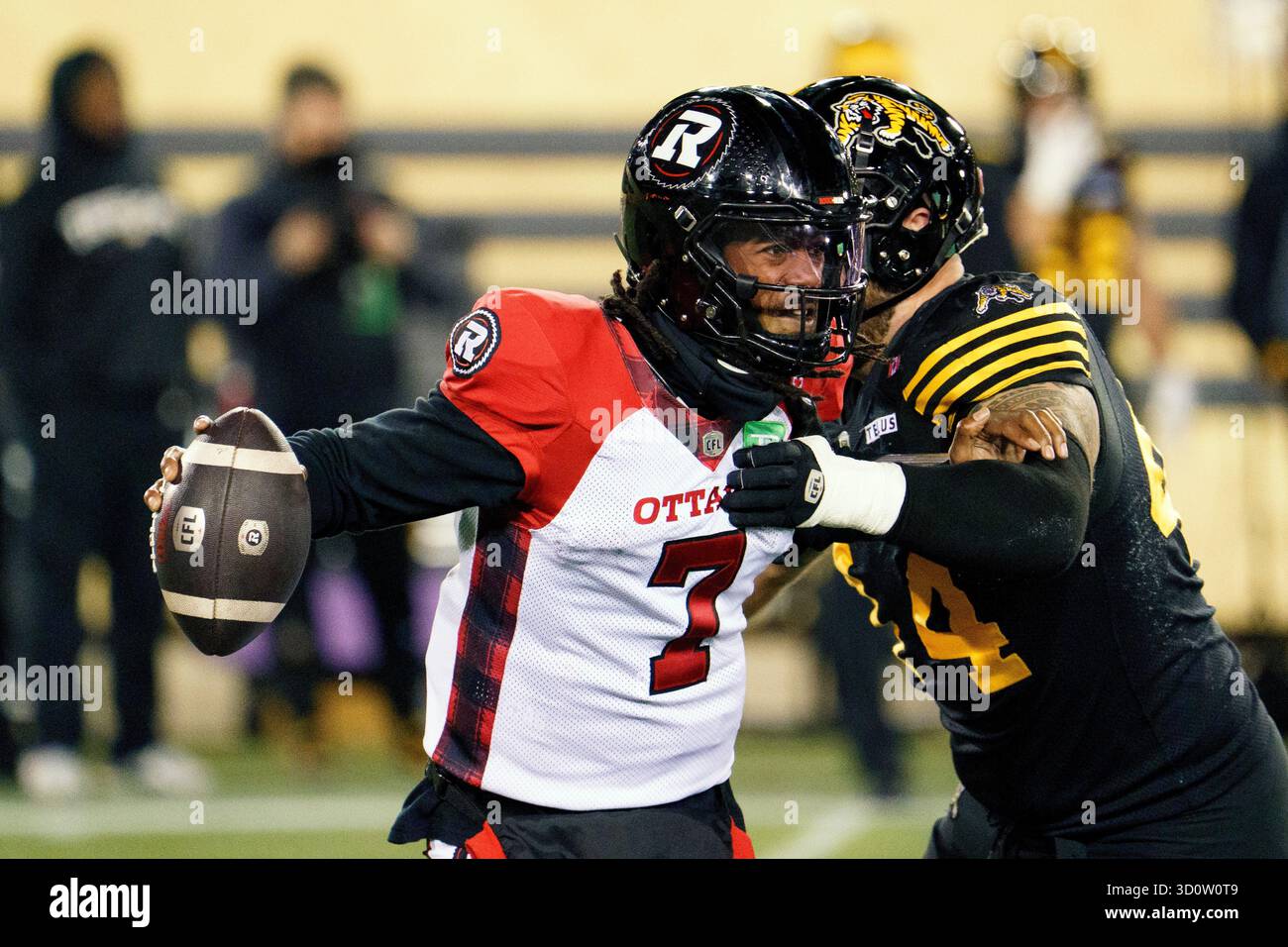 Ottawa Redblacks quarterback Tyrie Adams(7) is tackled by Hamilton ...