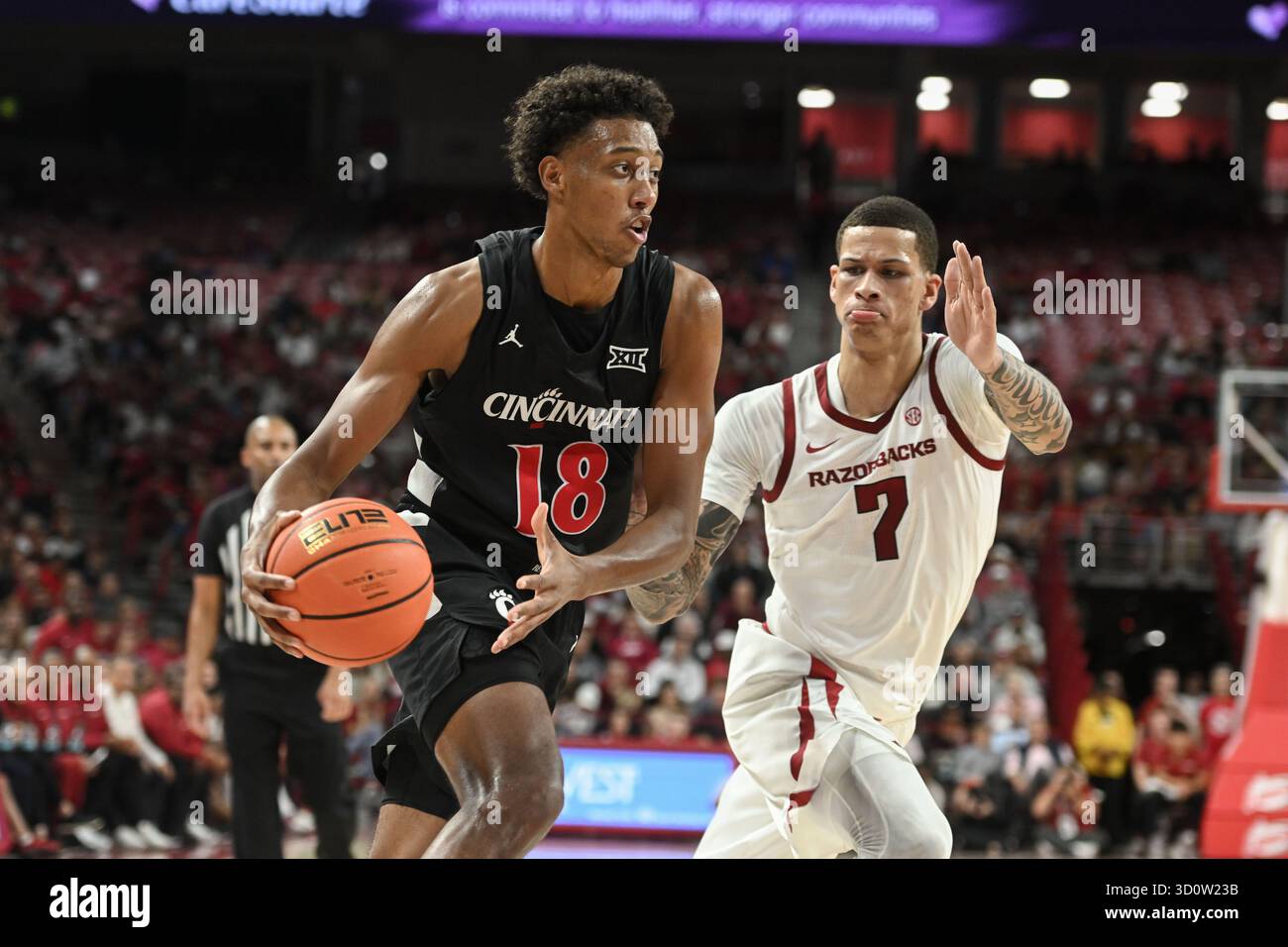 Cincinnati forward Baba Miller (18) tries to drive past Arkansas ...