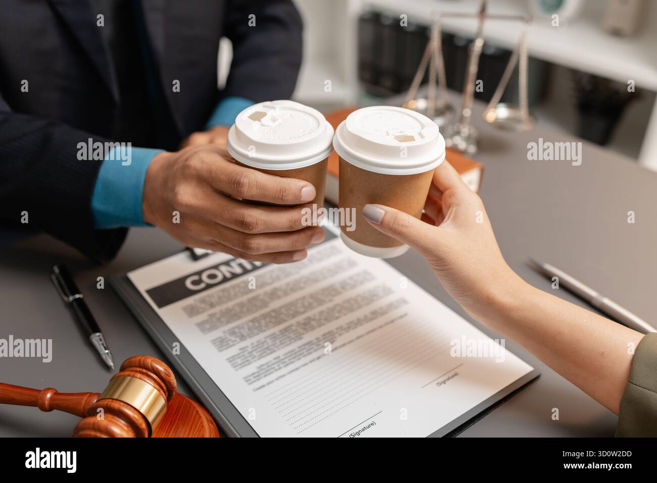 A lawyer and a client celebrate the successful completion of a legal ...