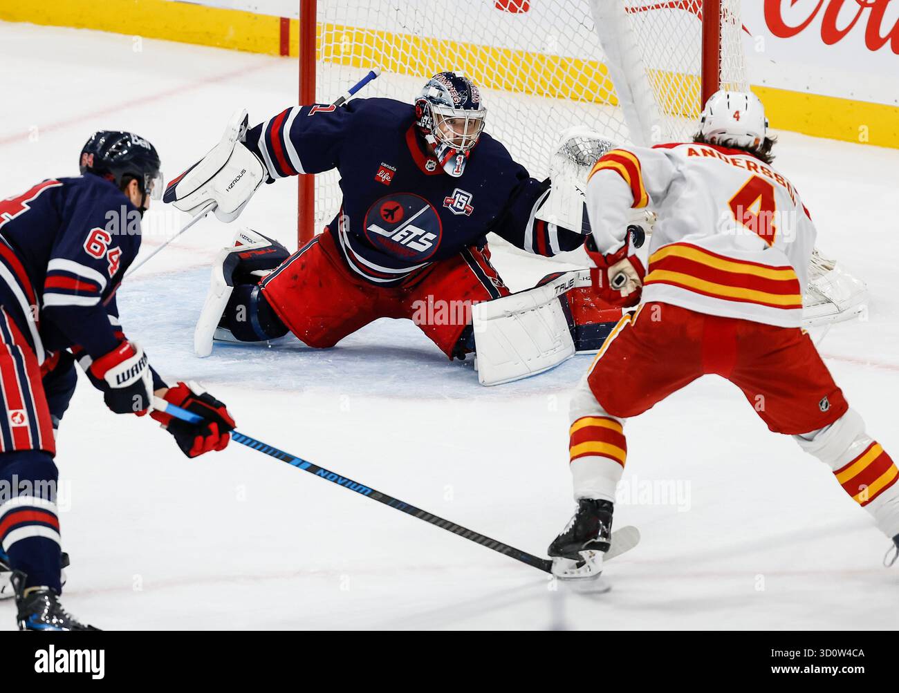 Winnipeg Jets goaltender Eric Comrie (1) saves the shot by Calgary ...