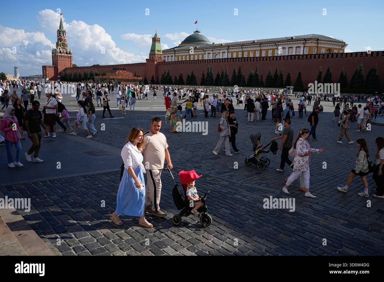 FILE - A family walks through Red Square in Moscow, Russia, Sunday, Aug ...
