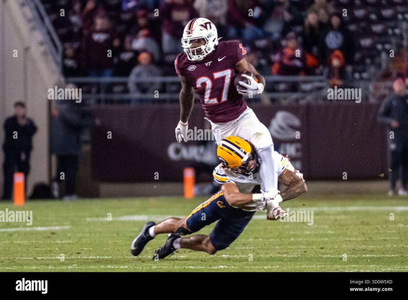 Virginia Tech running back Marcellous Hawkins (27) goes over California ...