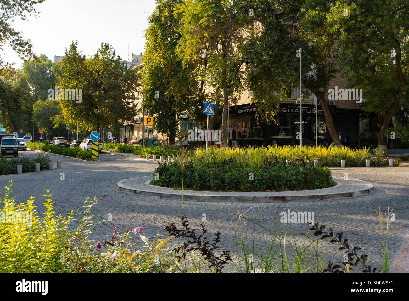 Tashkent, Uzbekistan, October, 2025. City street with roundabout, green ...