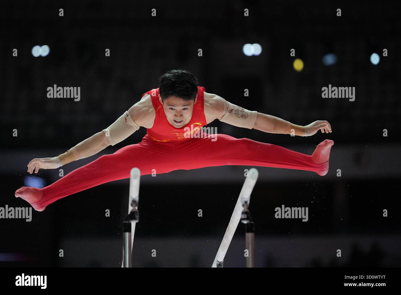 Shi Chong of China competes in the men's parallel bars final during the ...