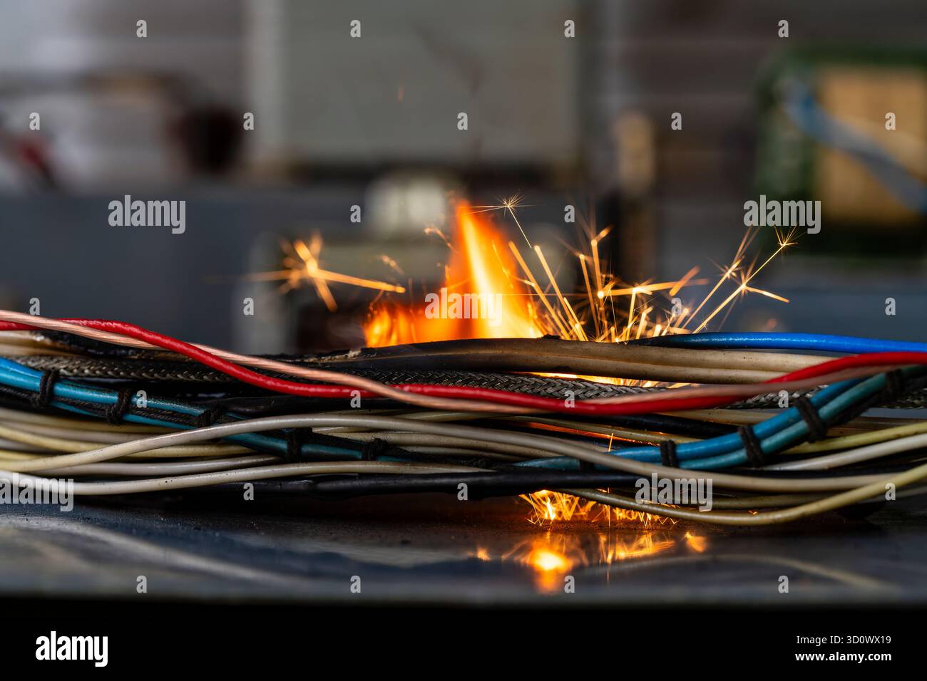 Flames, sparks, smoke between electrical cables, close up. Short ...