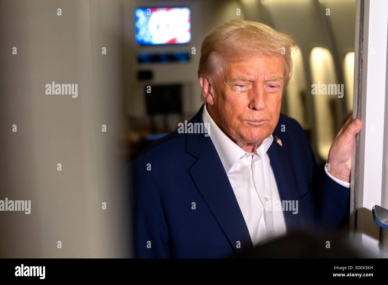 President Donald Trump speaks to reporters aboard Air Force One en ...